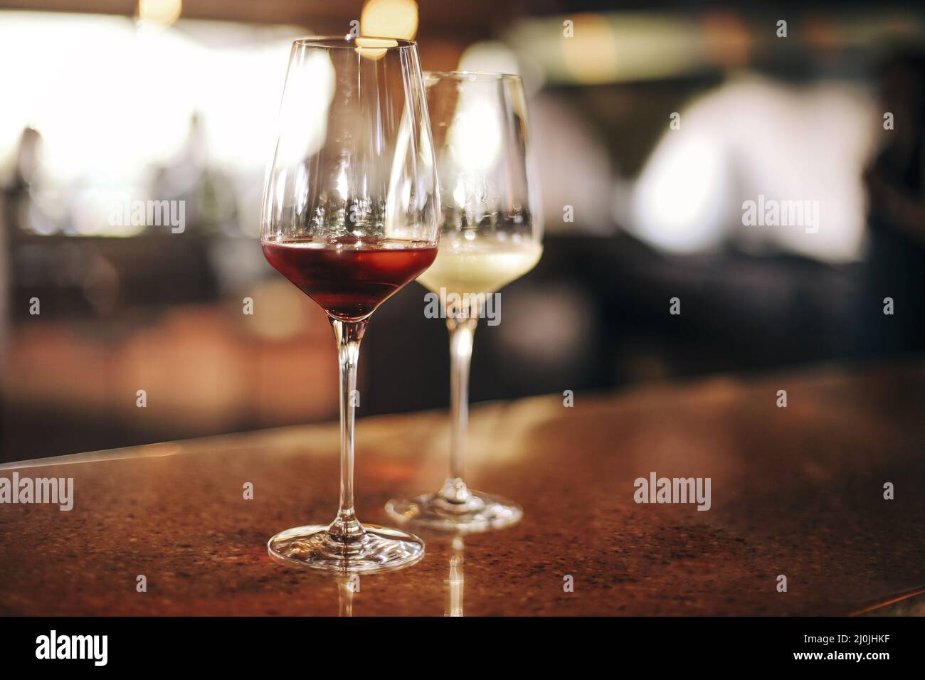 Wine bottle and glasses on the table, against the background of wine ...