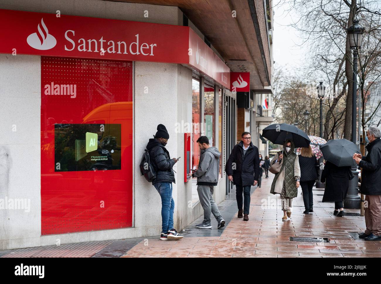 Madrid, Spain. 3rd Mar, 2022. Pedestrians walk past the Spanish ...