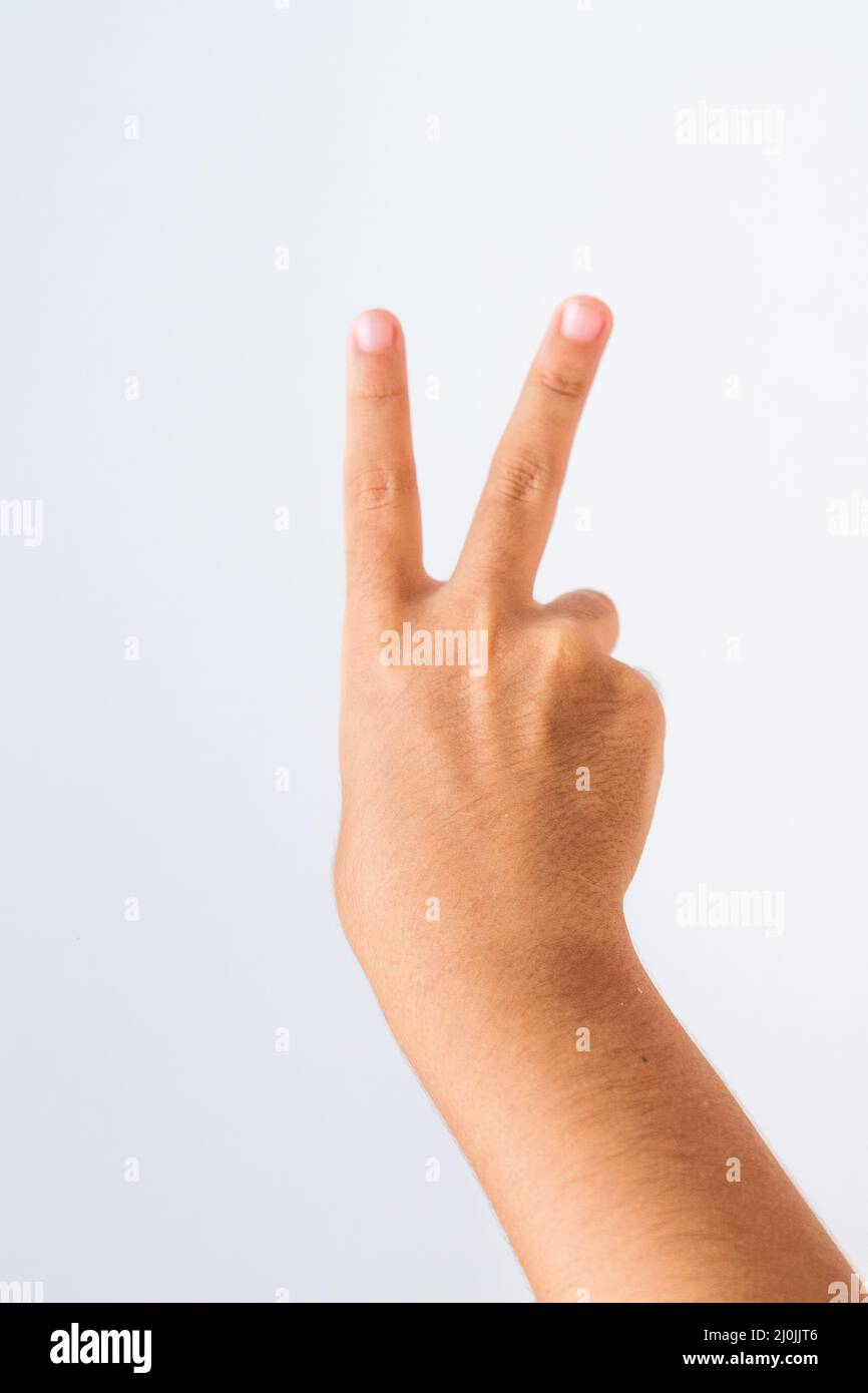 child making number 2 sign on a white background in Rio de Janeiro ...