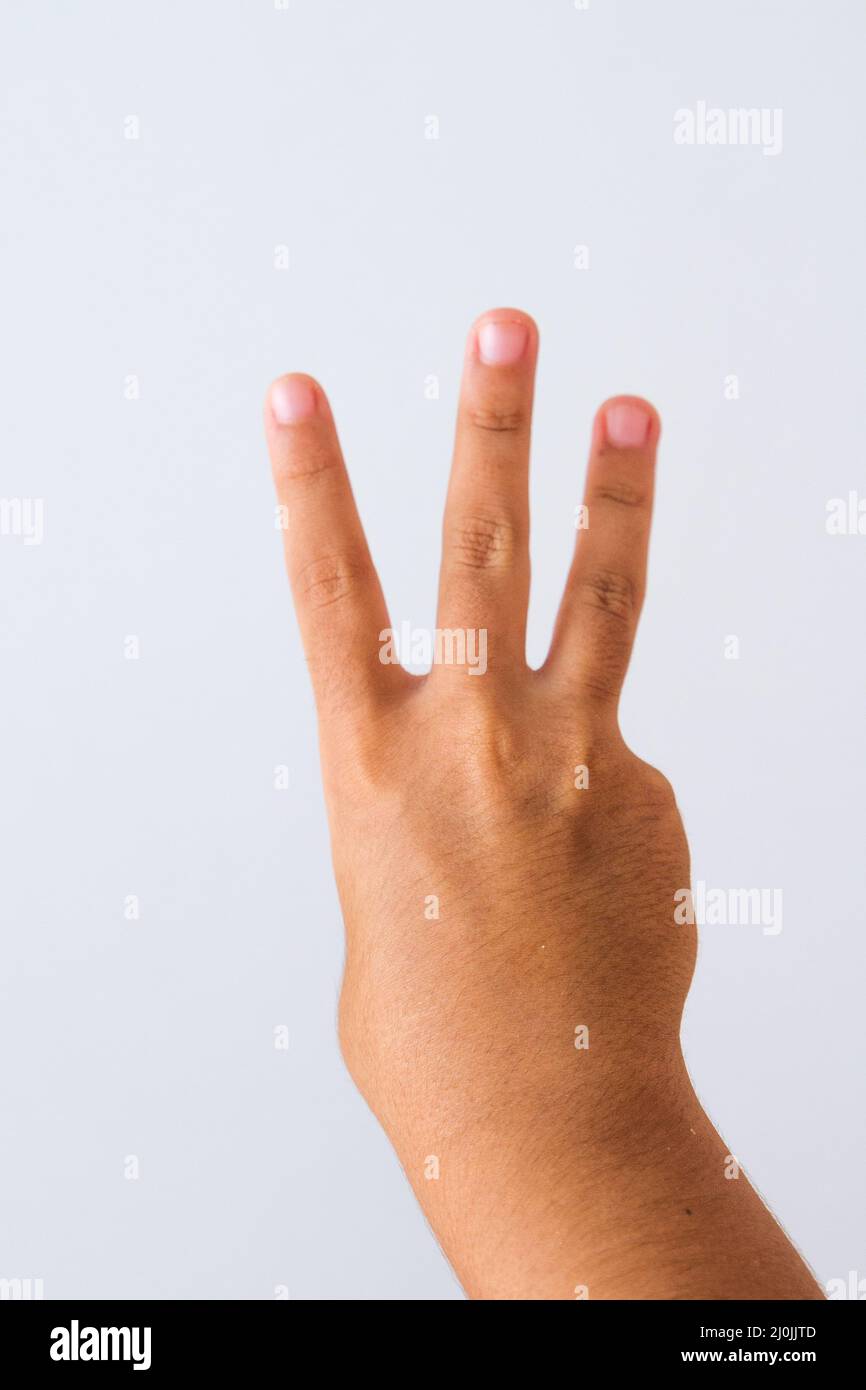 child making number three sign on a white background Stock Photo - Alamy