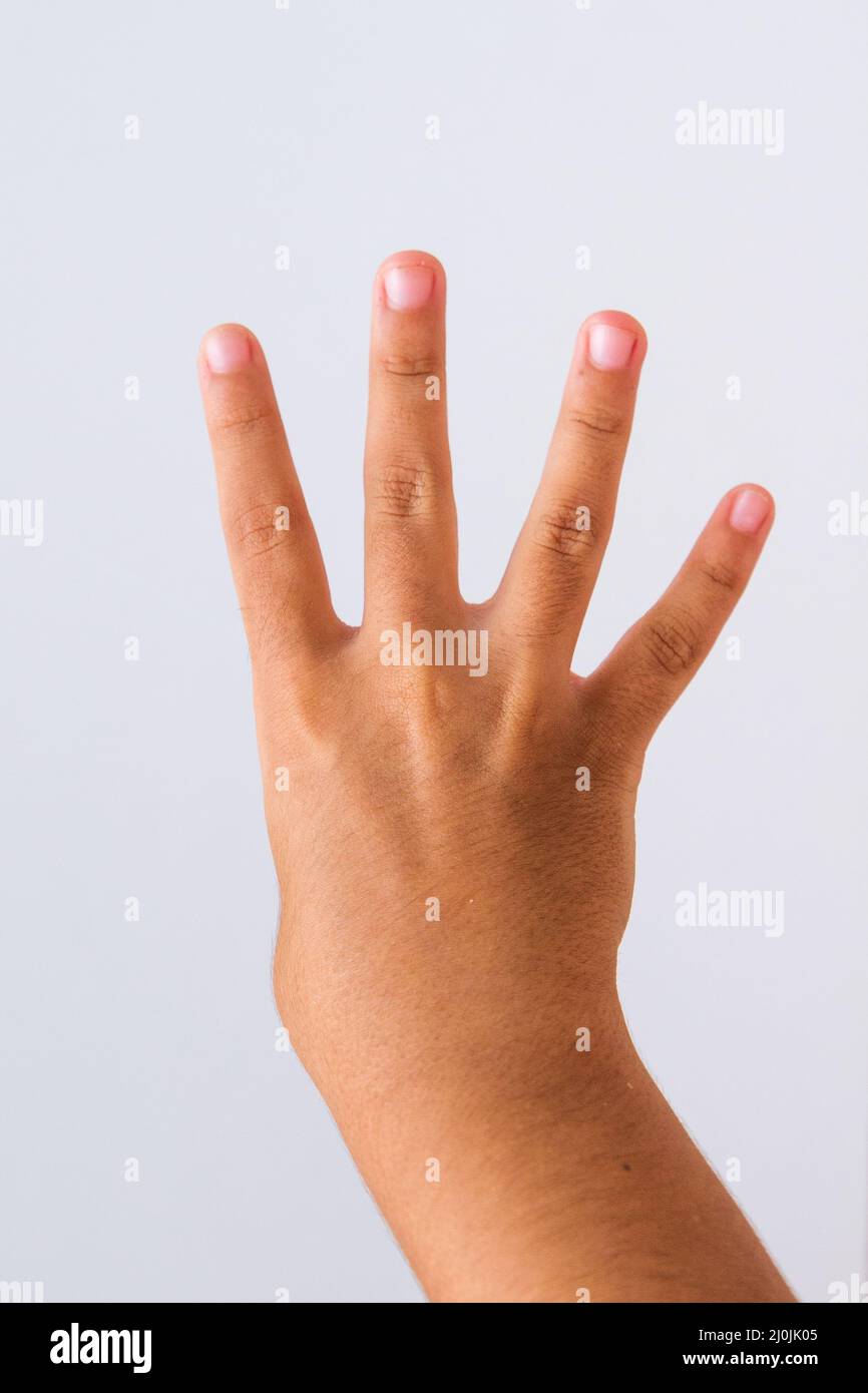 child making number four sign on a white background in Rio de Janeiro ...