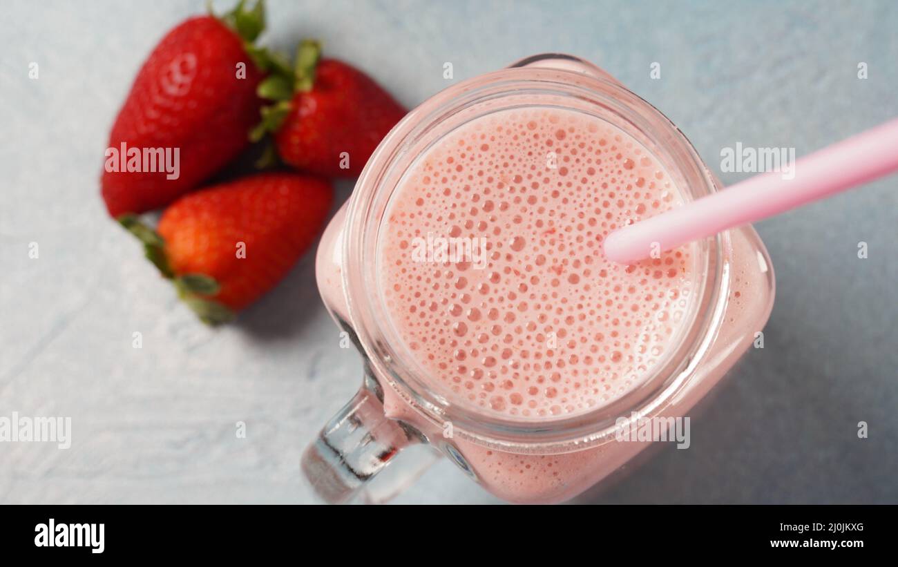 Strawberry milkshake in mason jars with fresh strawberries Stock Photo ...