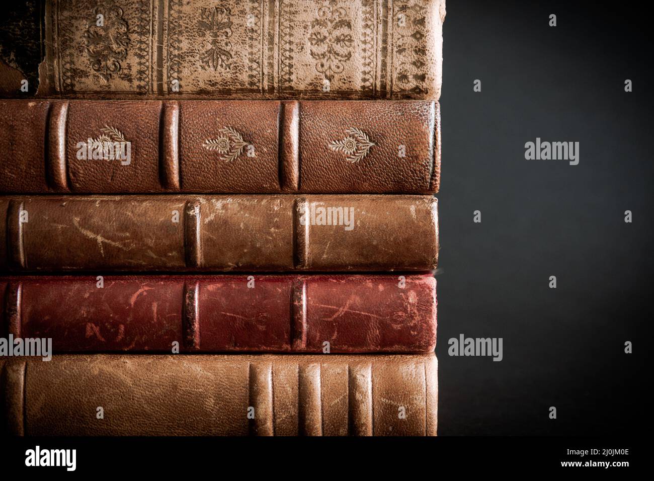 Stack of old books on black background Stock Photo - Alamy