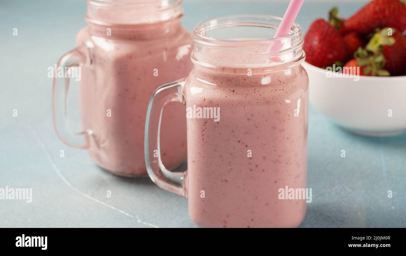 Strawberry milkshake in mason jars with fresh strawberries Stock Photo ...