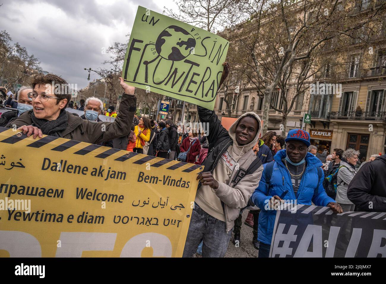 Barcelona, Spain. 19th Mar, 2022. Two protesters are seen holding a ...