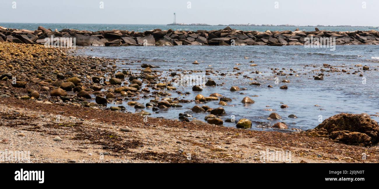Large jetty of rocks in Narragansett Bay creating a small cove off a ...