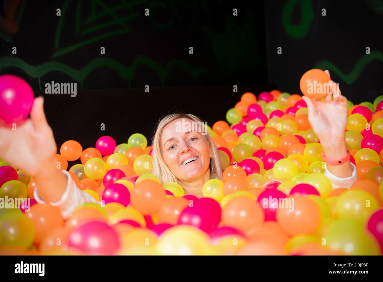 portrait of a girl in multi-colored balls Stock Photo - Alamy
