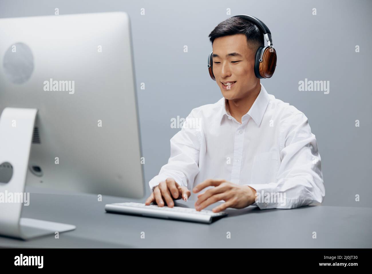 Asian man computer with keyboard on desk in office internet isolated ...