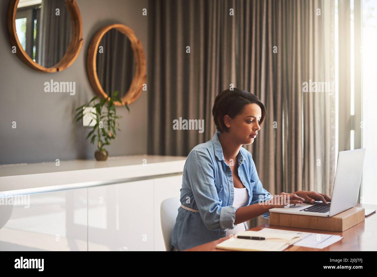 Managing pregnancy and her monthly bills. Shot of a pregnant young ...