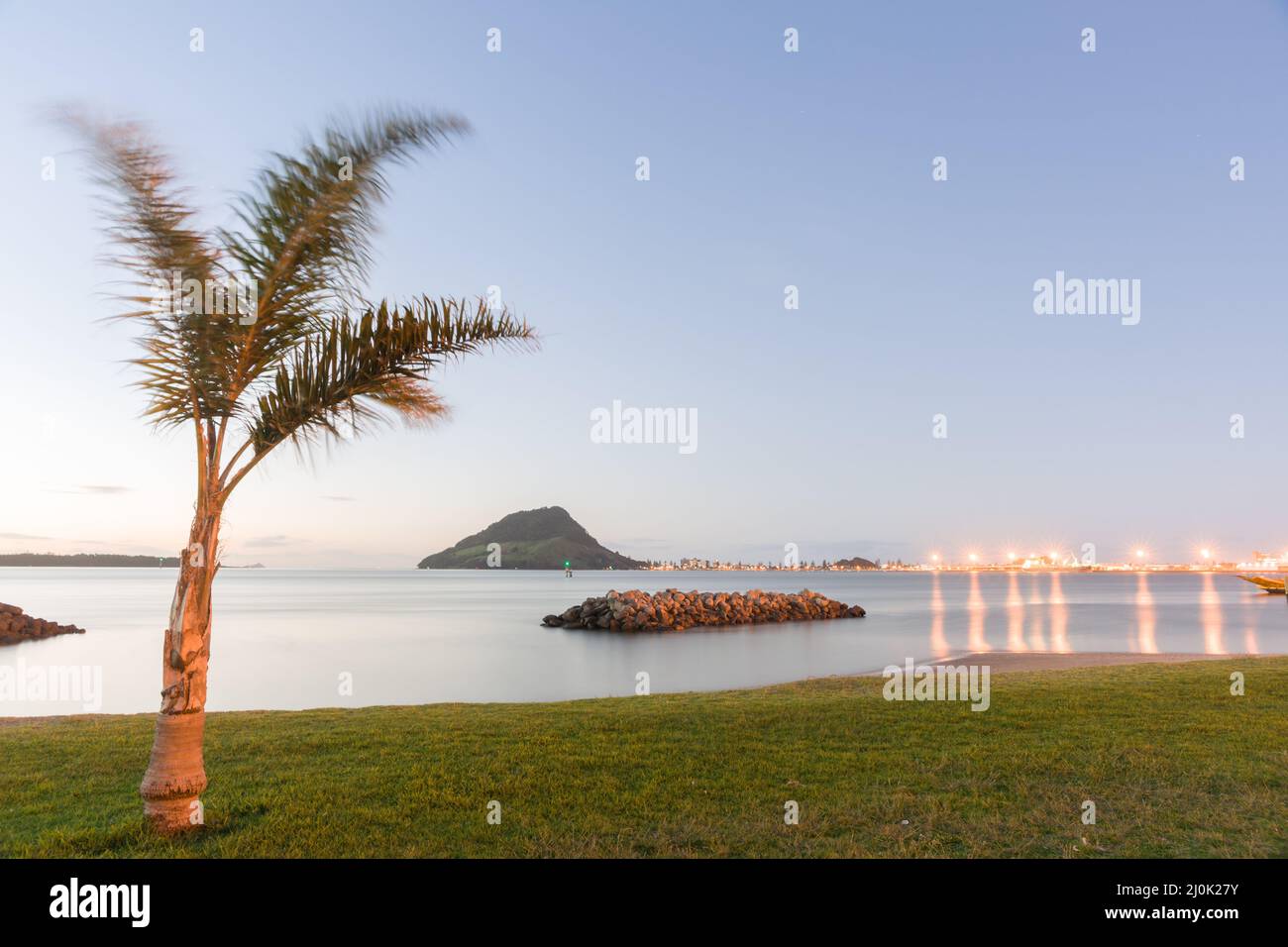 Tauranga harbour with lights from port reflecting across bay and Mount ...