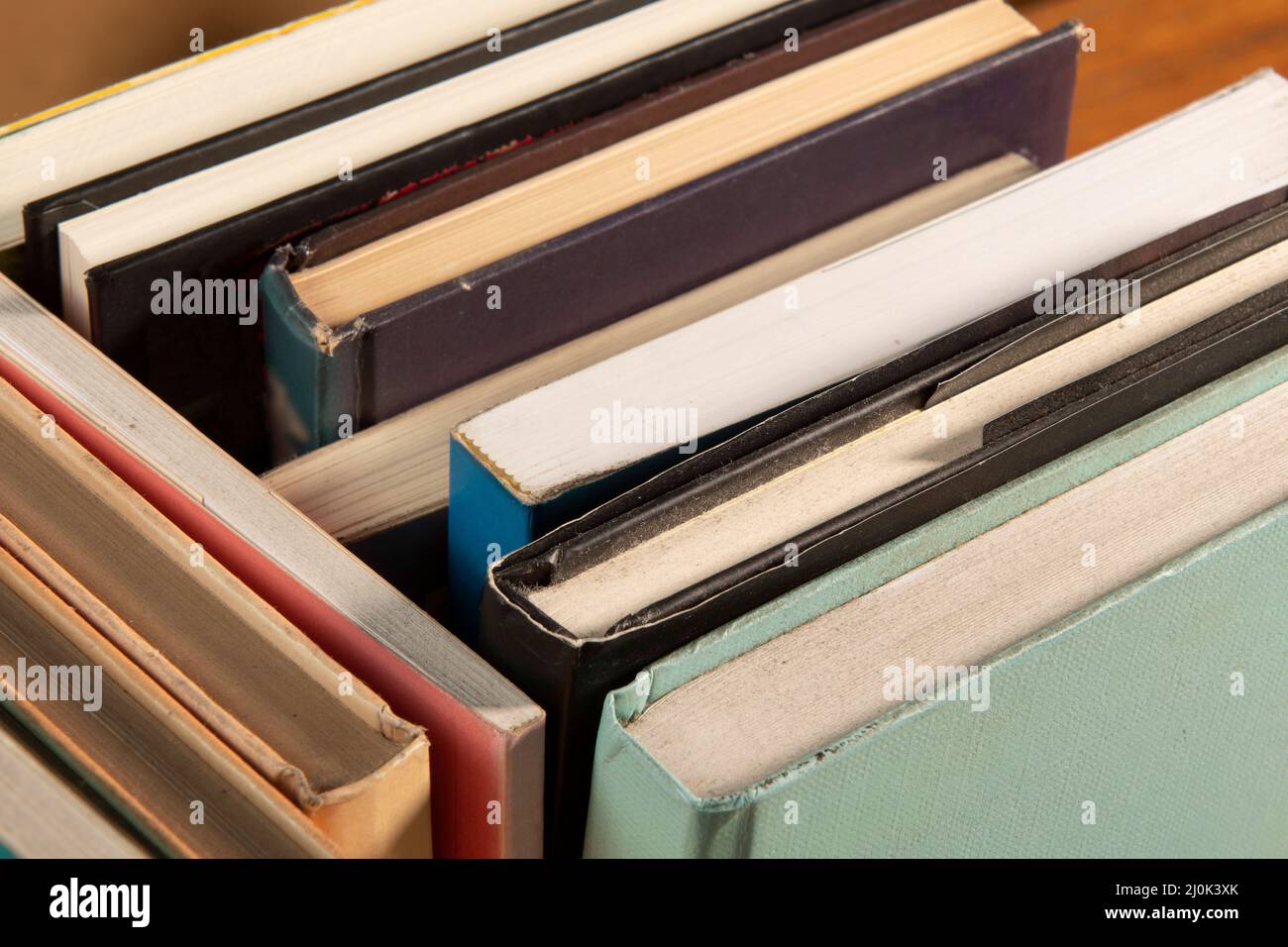 Close-up of background stack of old used books. Pile of vintage old ...