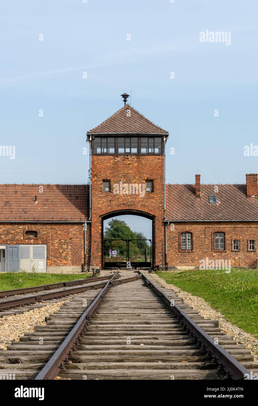 View of the gatehouse and train tracks at Auschwitz Concentration Camp ...