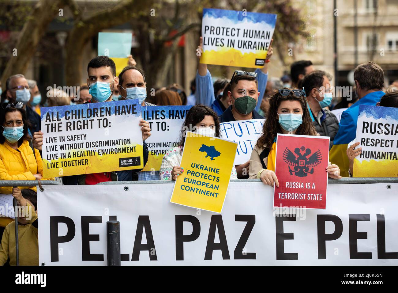 Protesters hold placards expressing their opinion during the ...