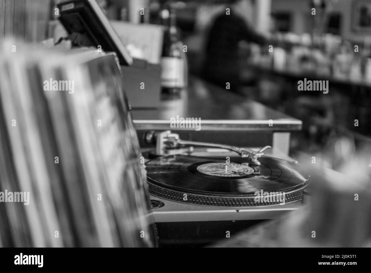 Grayscale of a record player at a bar Stock Photo - Alamy