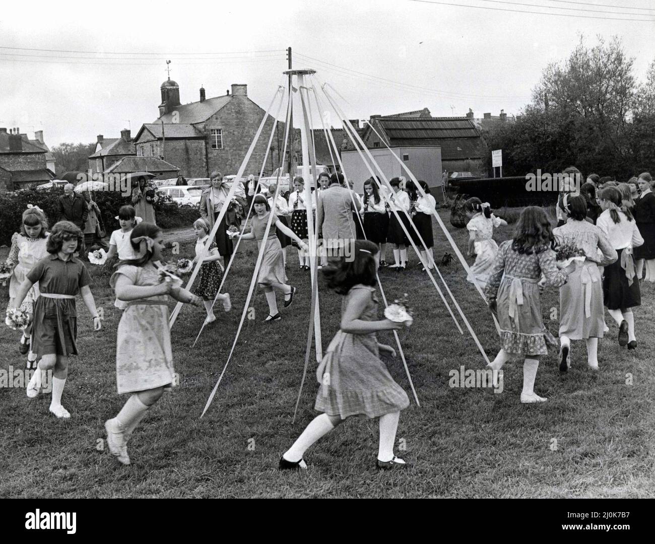 Children dancing around the maypole on the site of the car park ...