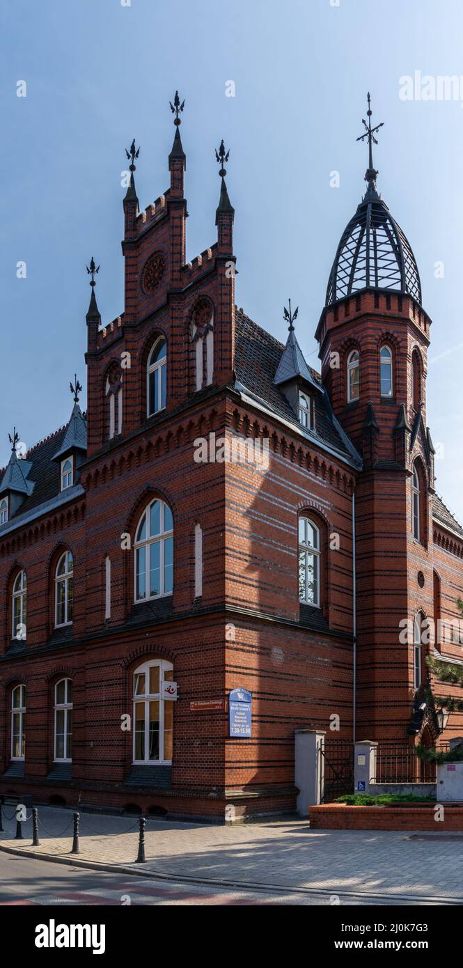 Historic red brick Gothic architecture building in downtown Gniezno ...