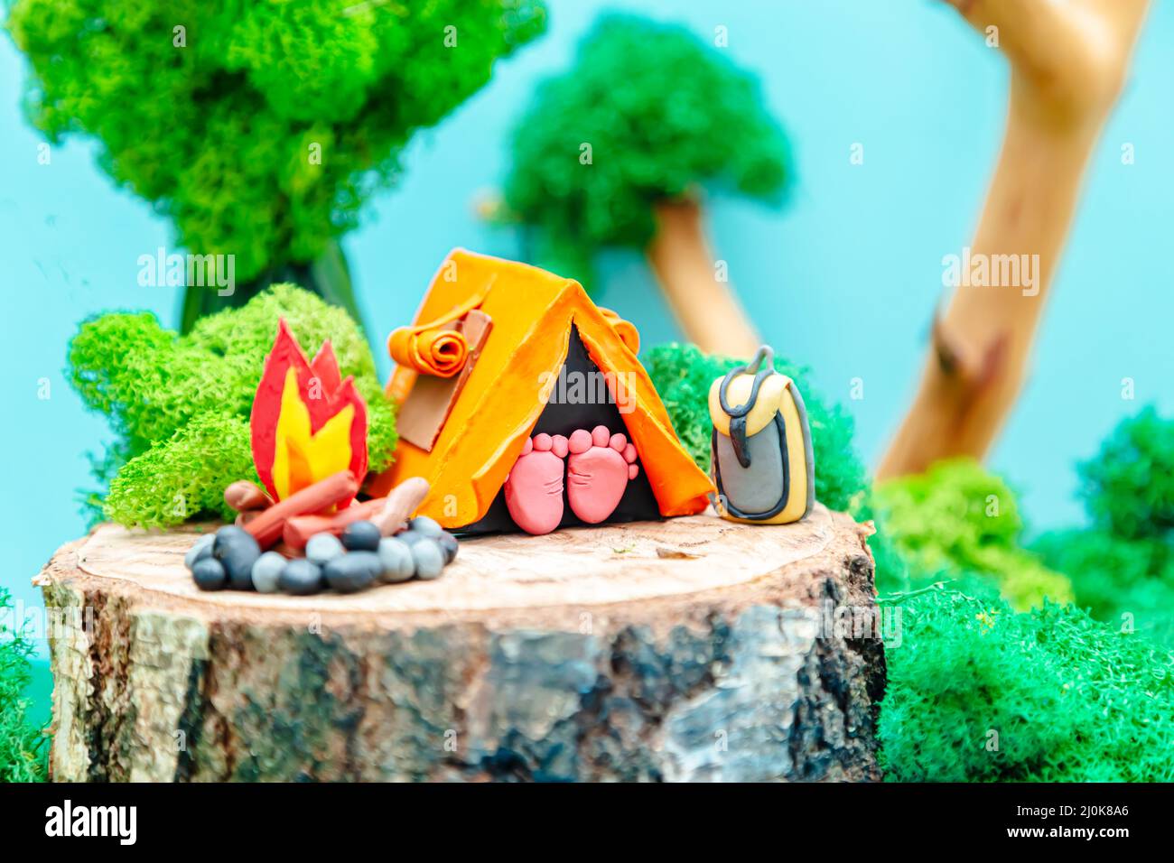 Tourist camp. Plasticine landscape with a tent, a campfire and a ...