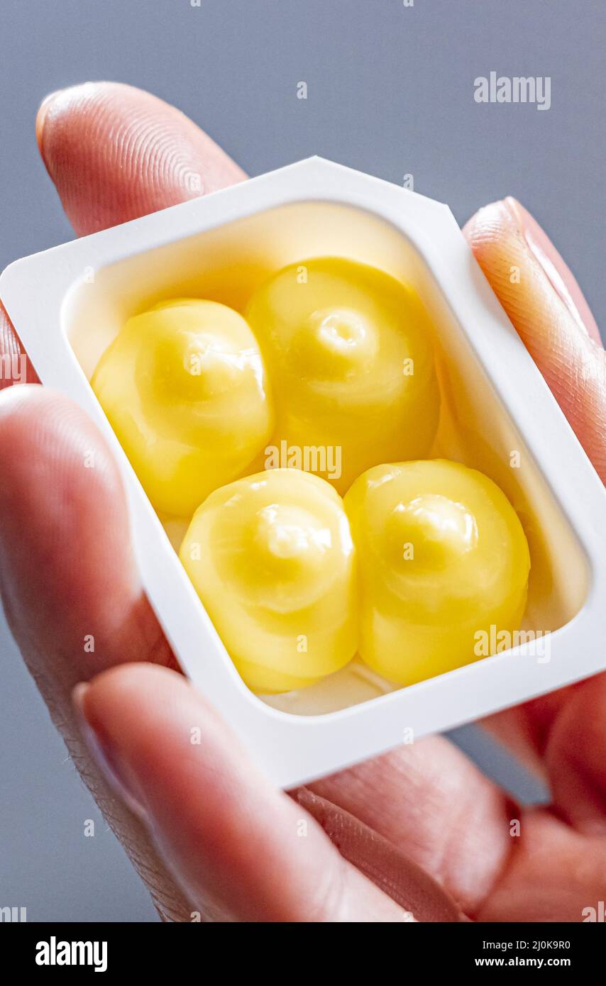 Small packet of butter in hand on the plane Stock Photo - Alamy