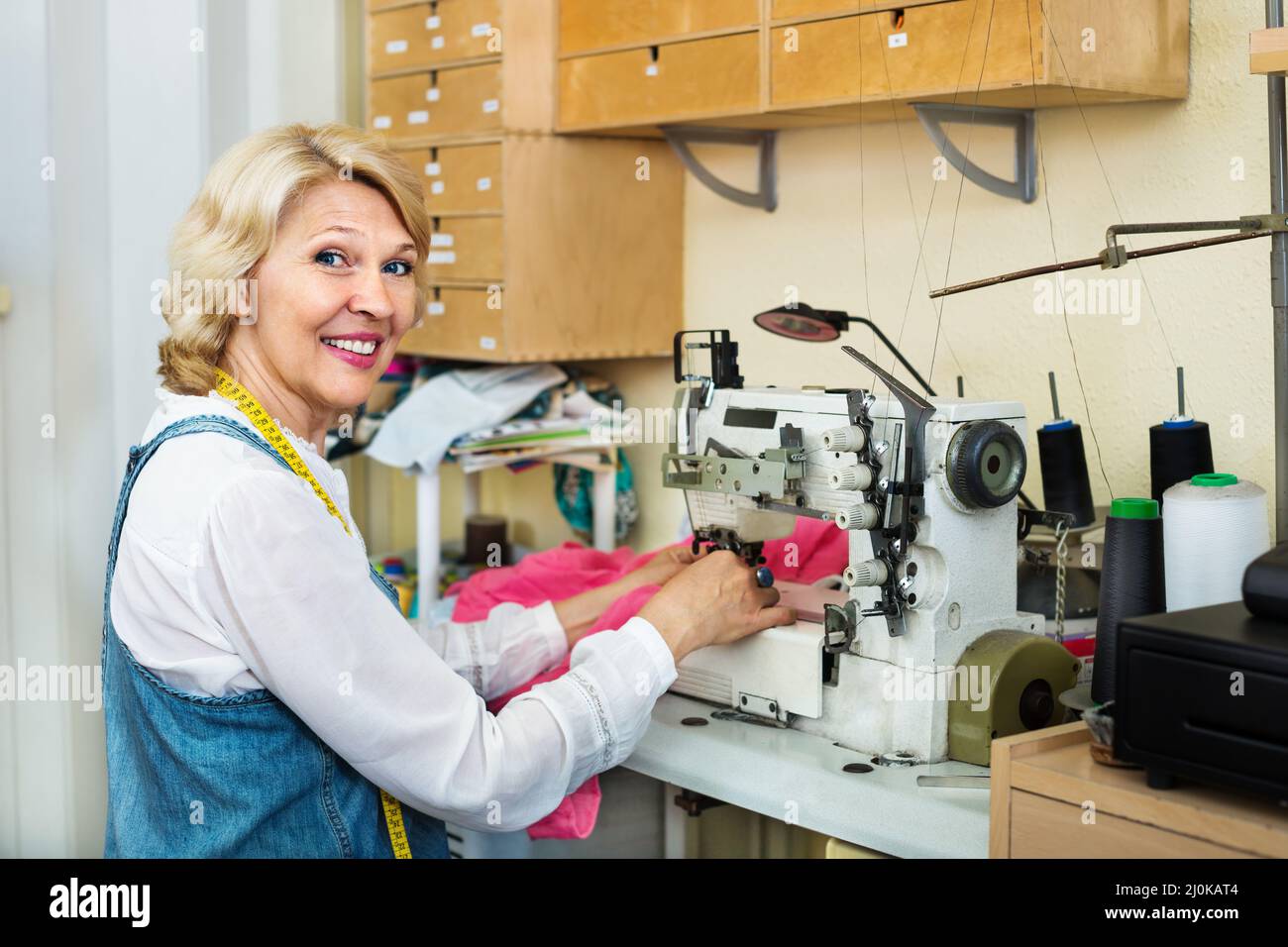 Female tailor working on sewing machine Stock Photo - Alamy