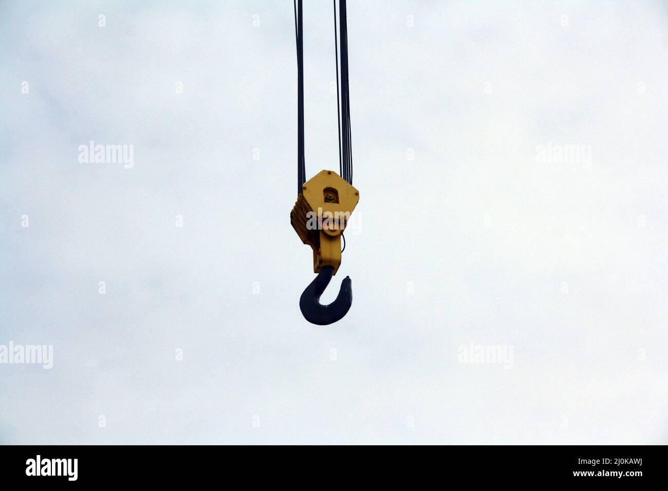 Yellow hook of a hoist crane in the port Stock Photo - Alamy