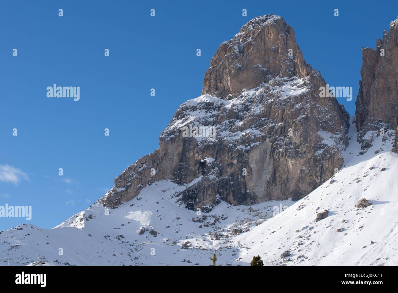 Stunning winter landscape of snow-capped rocky mountains under a blue ...