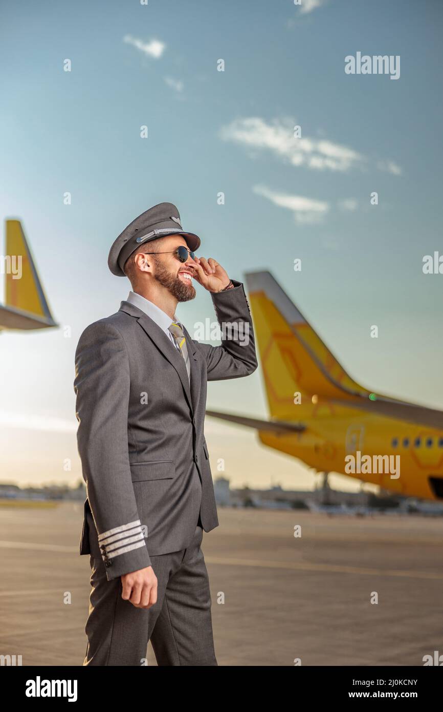 Cheerful aircraft pilot standing outdoors at airfield Stock Photo - Alamy