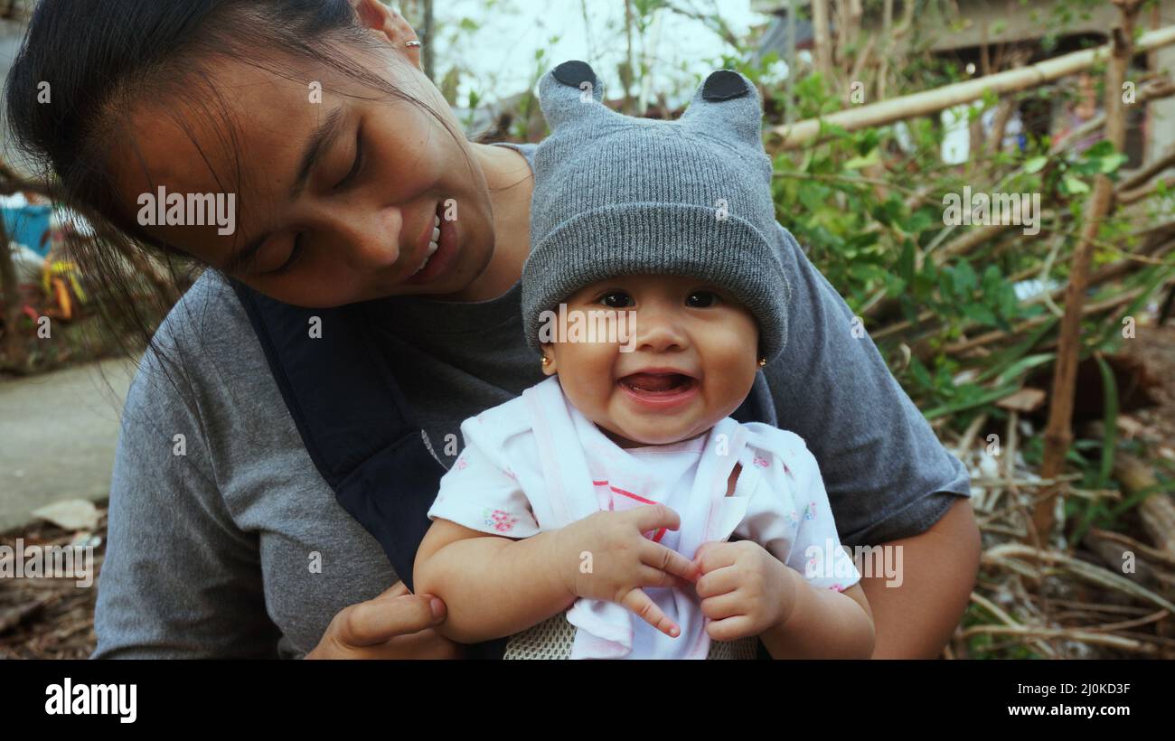 Mother and child smiling after the typhoon in Philippines Stock Photo ...