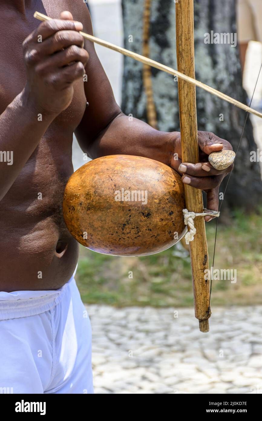 Musician playing a traditional Brazilian percussion instrument called ...