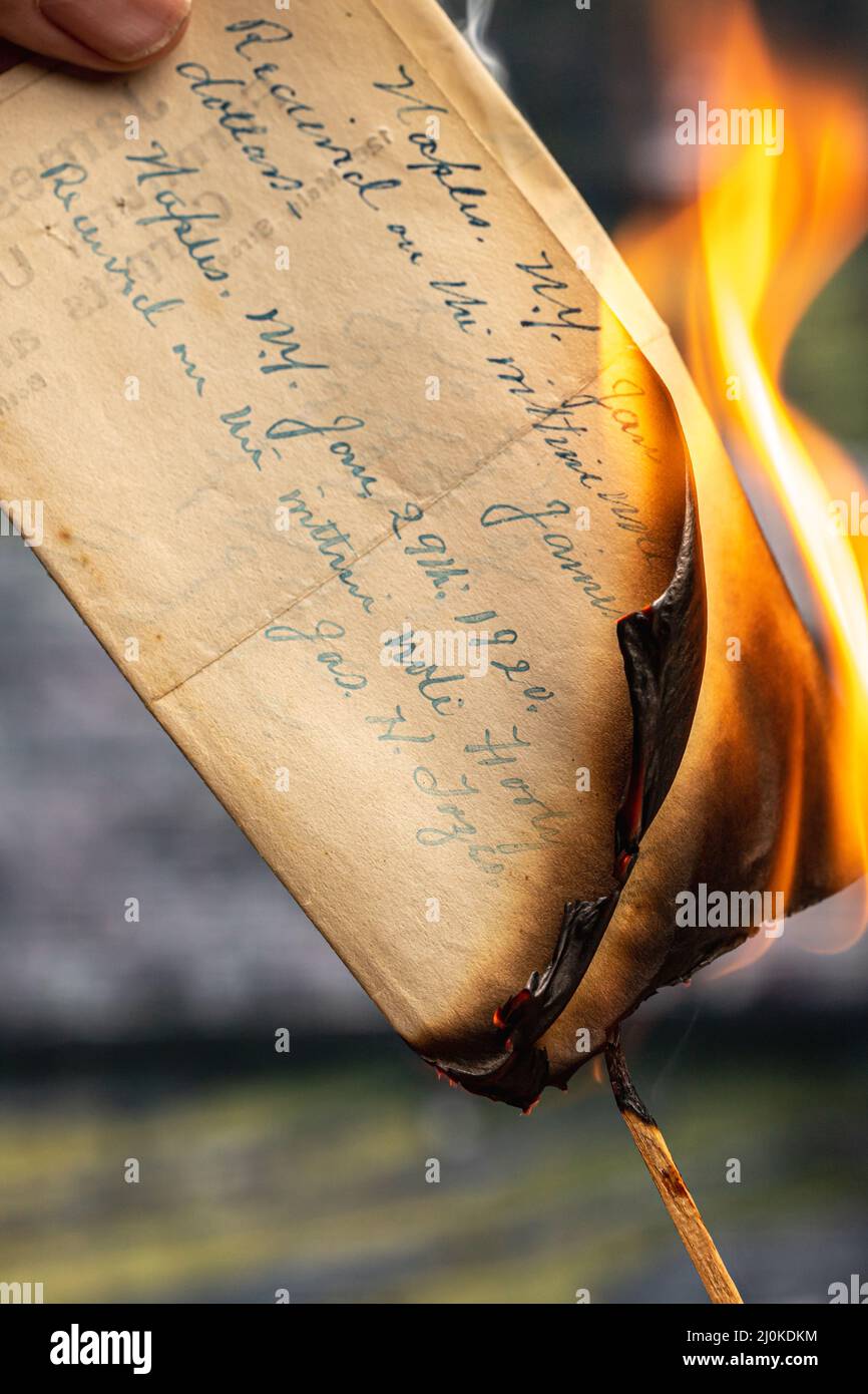 Flames rise from burning paperwork Stock Photo - Alamy