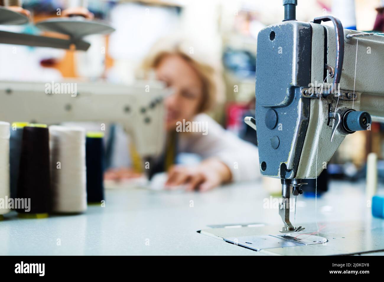 Sewing machine on factory, closeup Stock Photo - Alamy