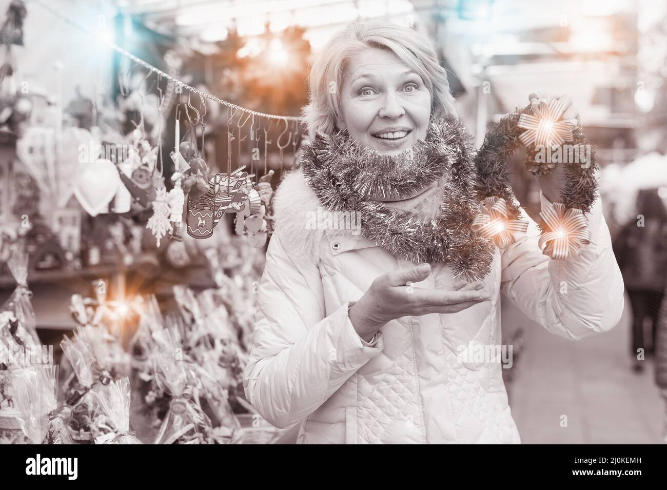 Adult woman is choosing Christmas wreath for house in the market Stock ...