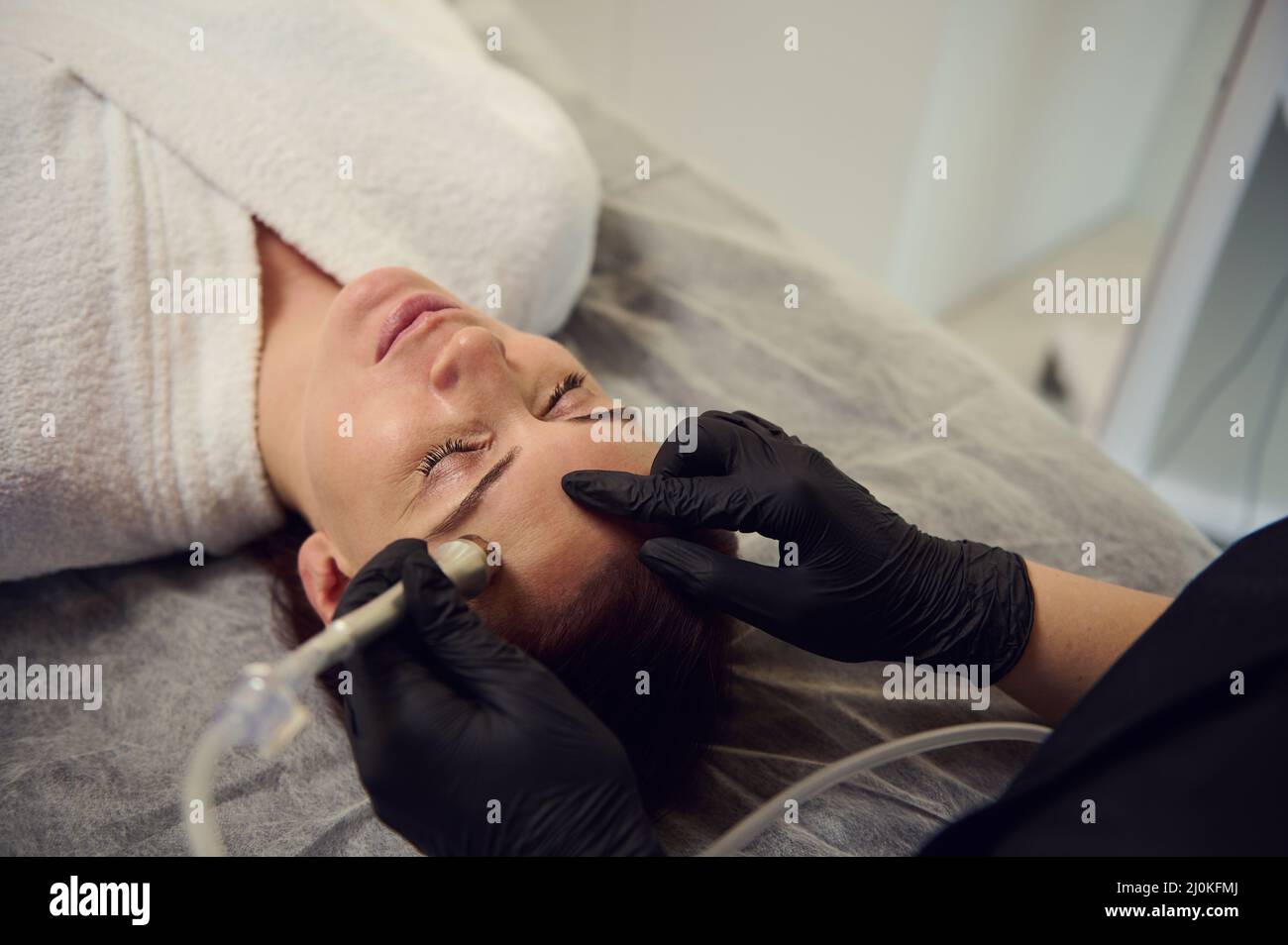 Overhead view attractive woman receiving a beauty treatment on her face ...