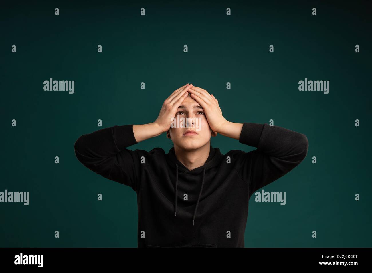 Regretful expression of a young man. Cropped studio portrait of male ...