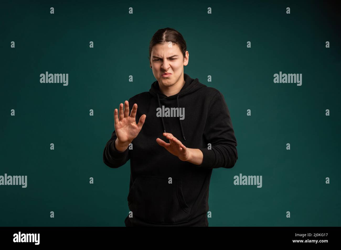 Disgusting expression of a young man. Cropped studio portrait of male ...