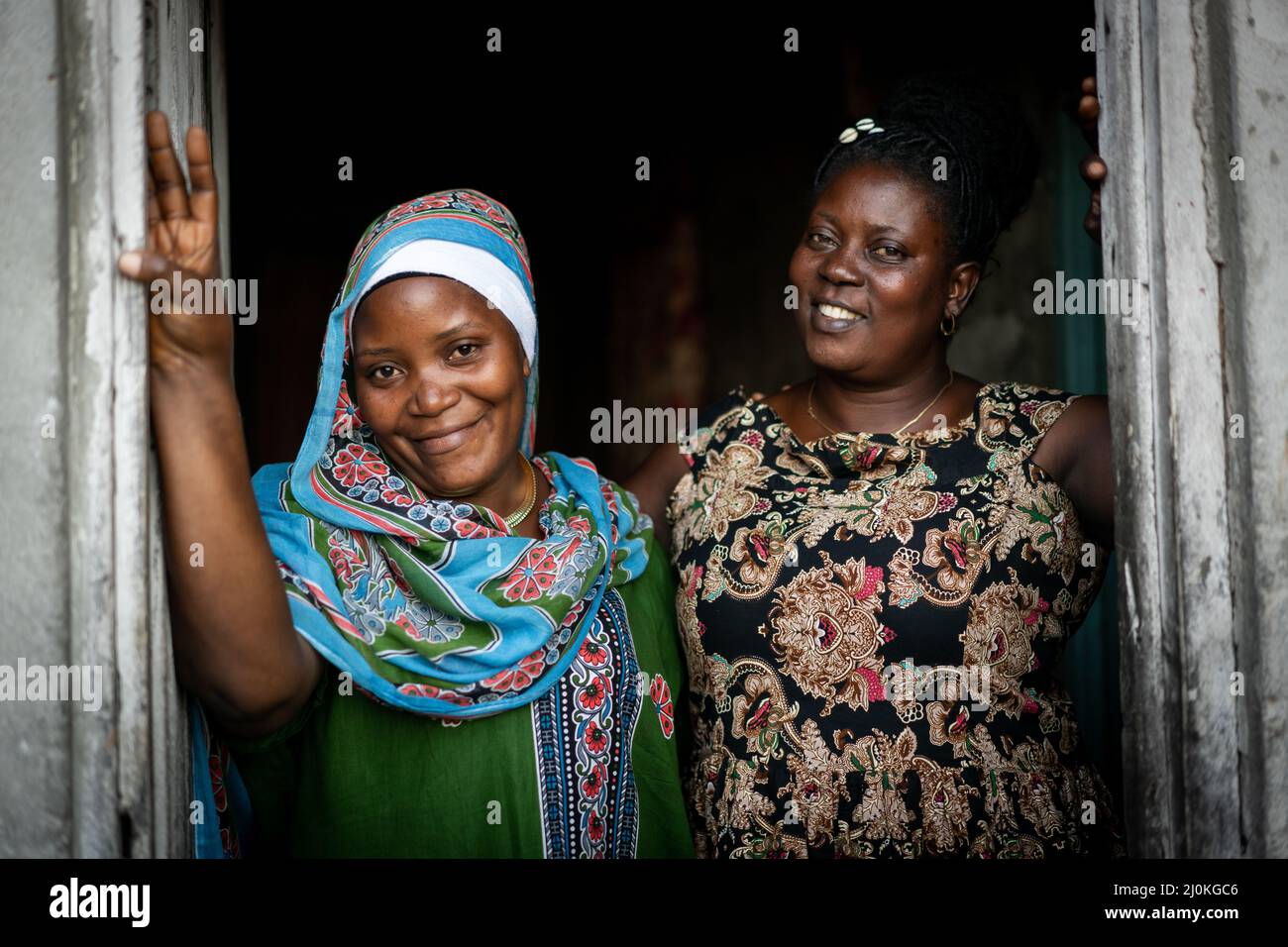 Two best friends standing on the door Stock Photo - Alamy
