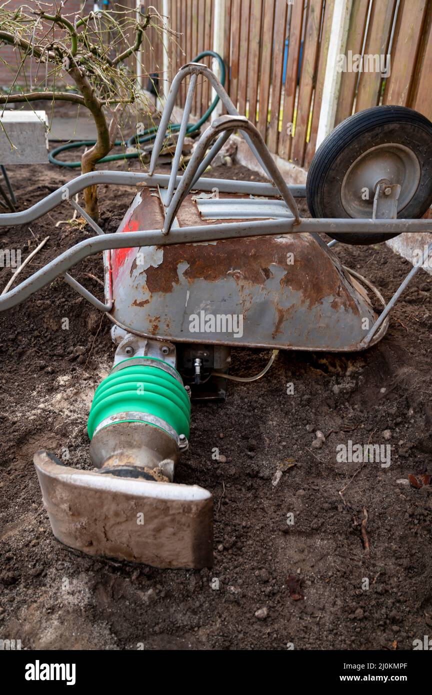 Work on laying irregularly shaped concrete tiles in the garden during ...
