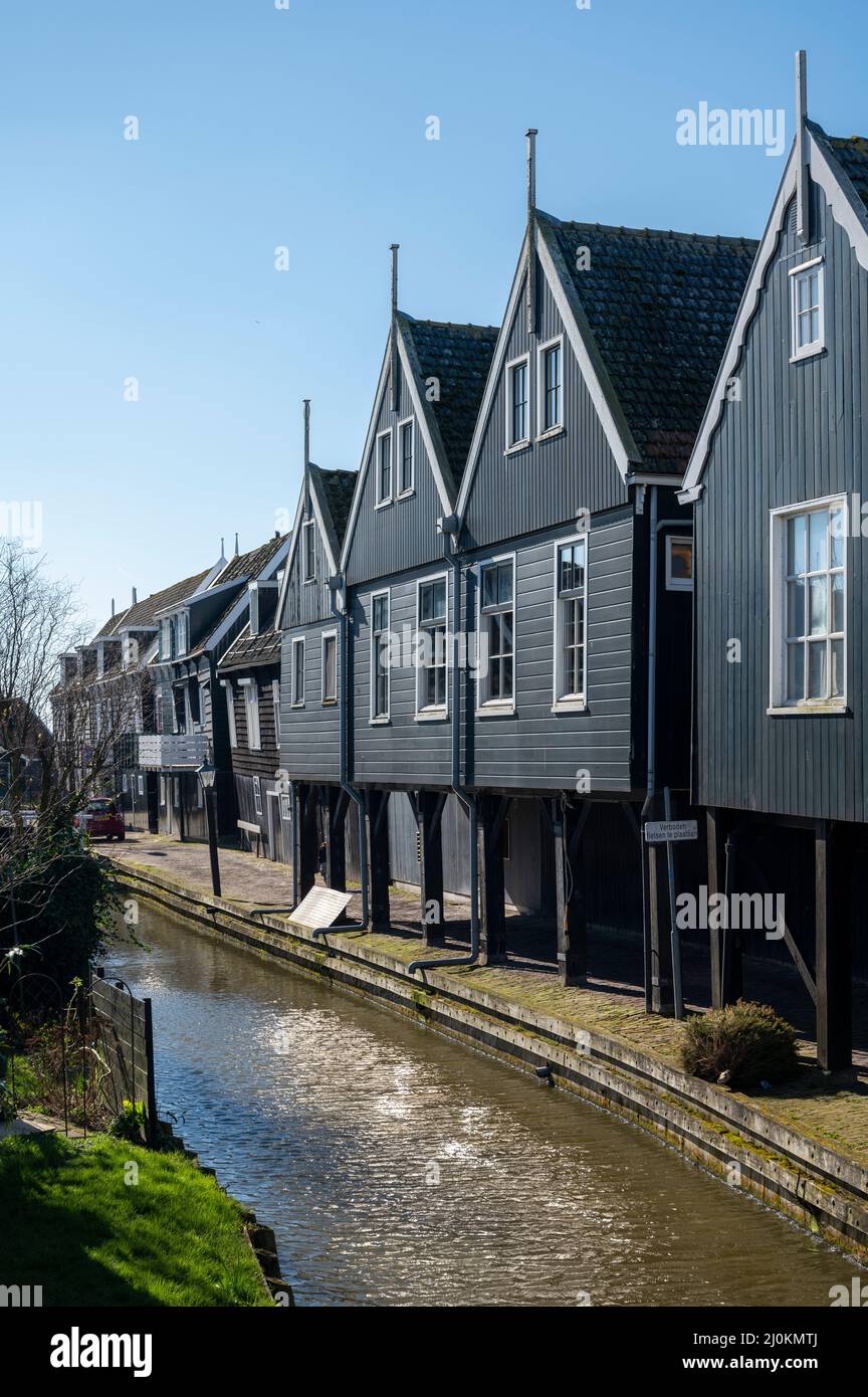 Walking on sunny spring day in small Dutch town Marken with wooden ...