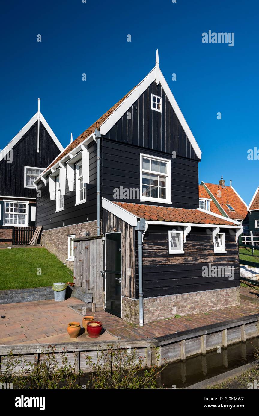 Walking on sunny spring day in small Dutch town Marken with wooden ...