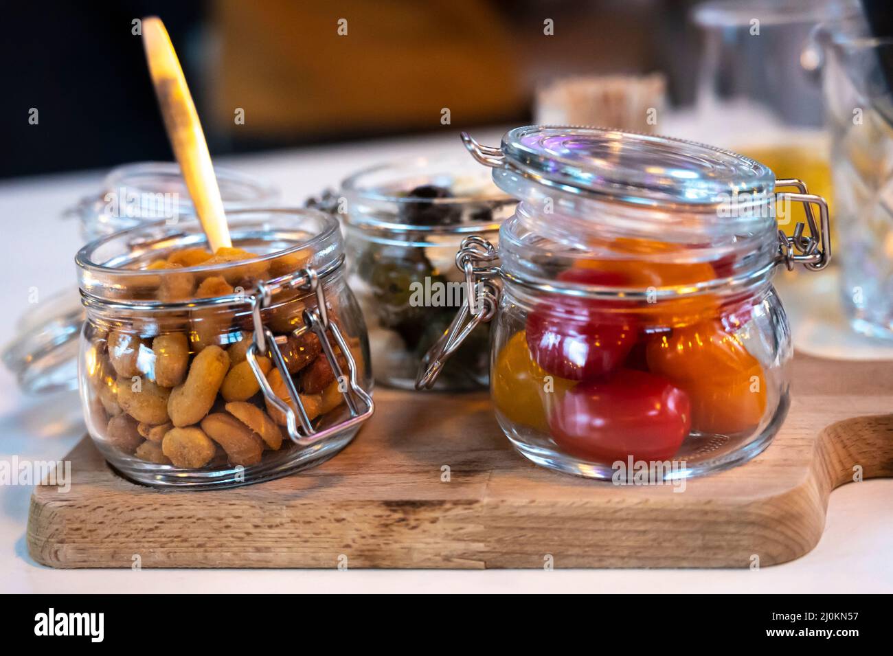 Glass jars with healthy party snacks served in bar, tasty appetisers ...