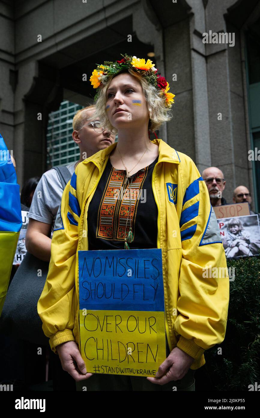 New York, United States. 19th Mar, 2022. Protester with flowers on her ...