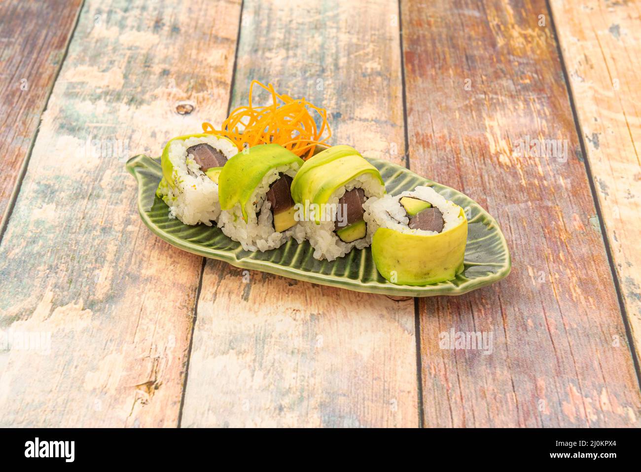 Four-piece portion of red tuna uramaki with avocado, cream cheese, nori ...