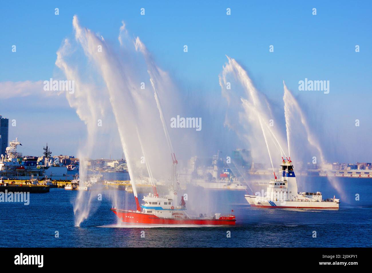 Fire fighting vessels to the water discharge training Stock Photo - Alamy