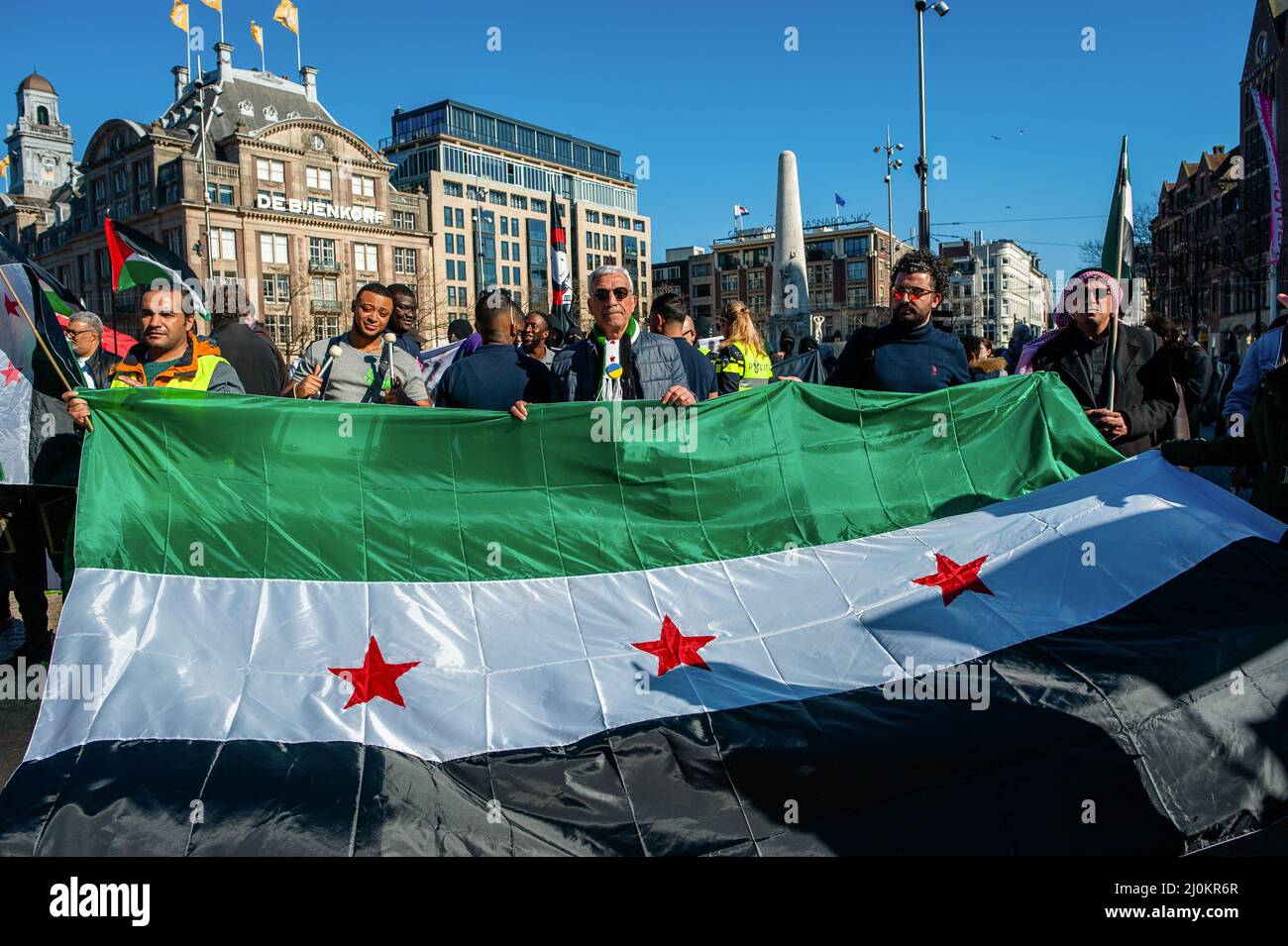 A group of Syrian men is seen holding a big Syrian flag during the ...