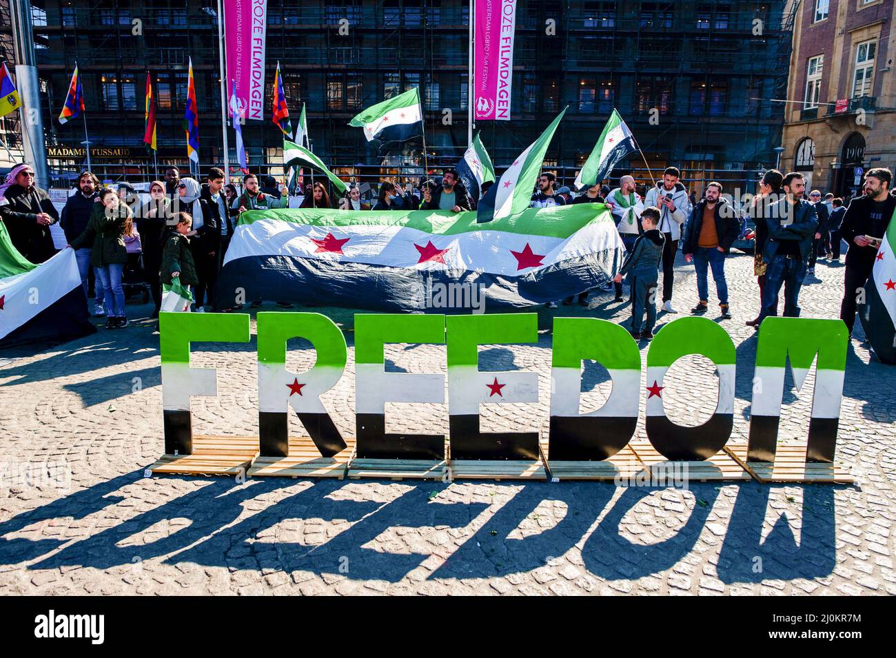 Syrian people are seen standing around the word FREEDOM made with ...