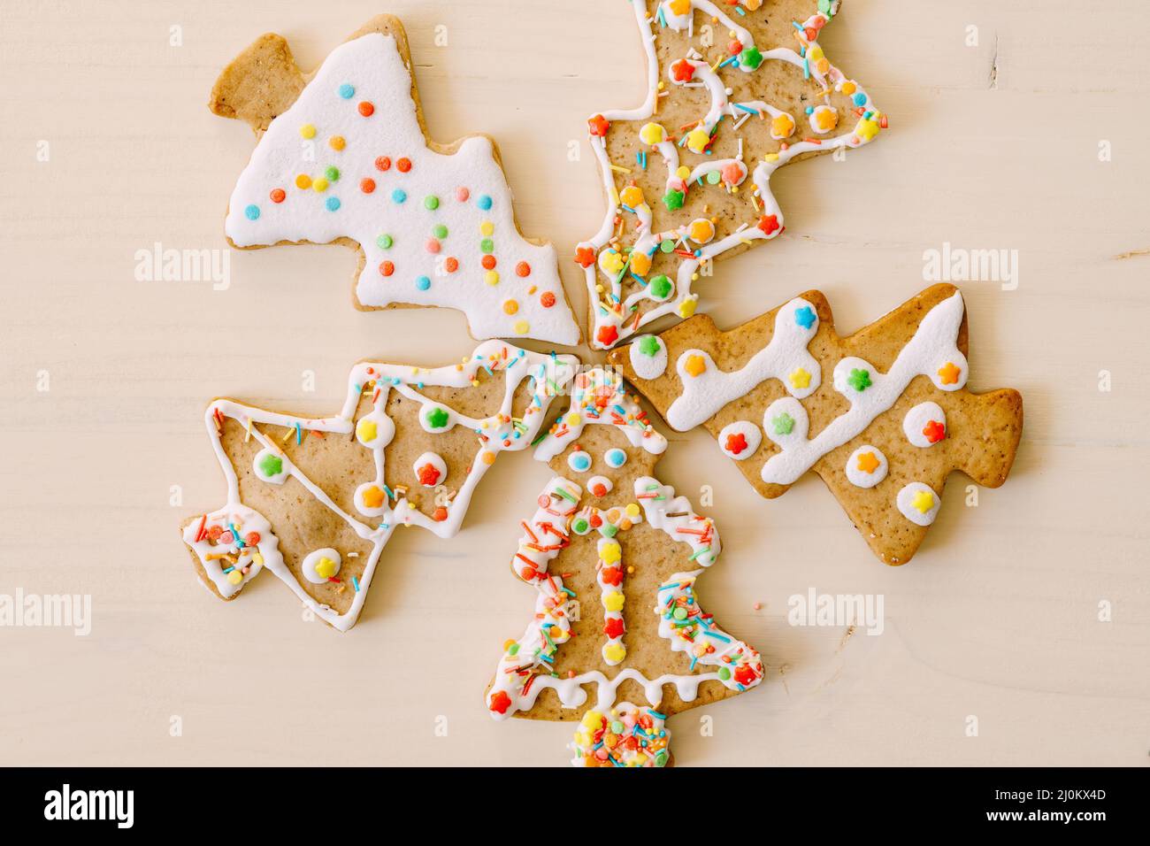 Five herringbone gingerbread cookies, differently decorated with glaze ...
