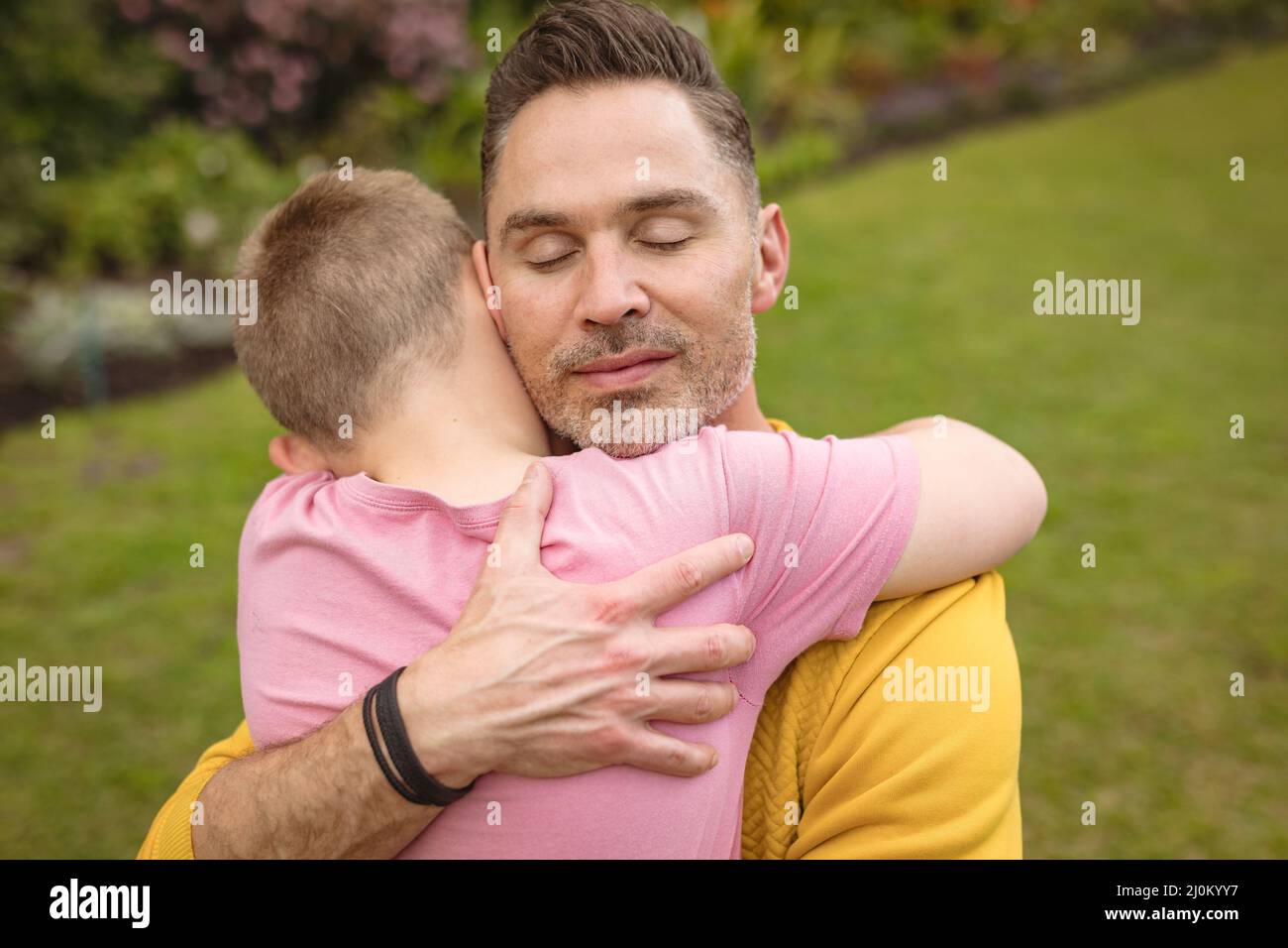 Close Up View Of Caucasian Father And Son Hugging Each Other In The
