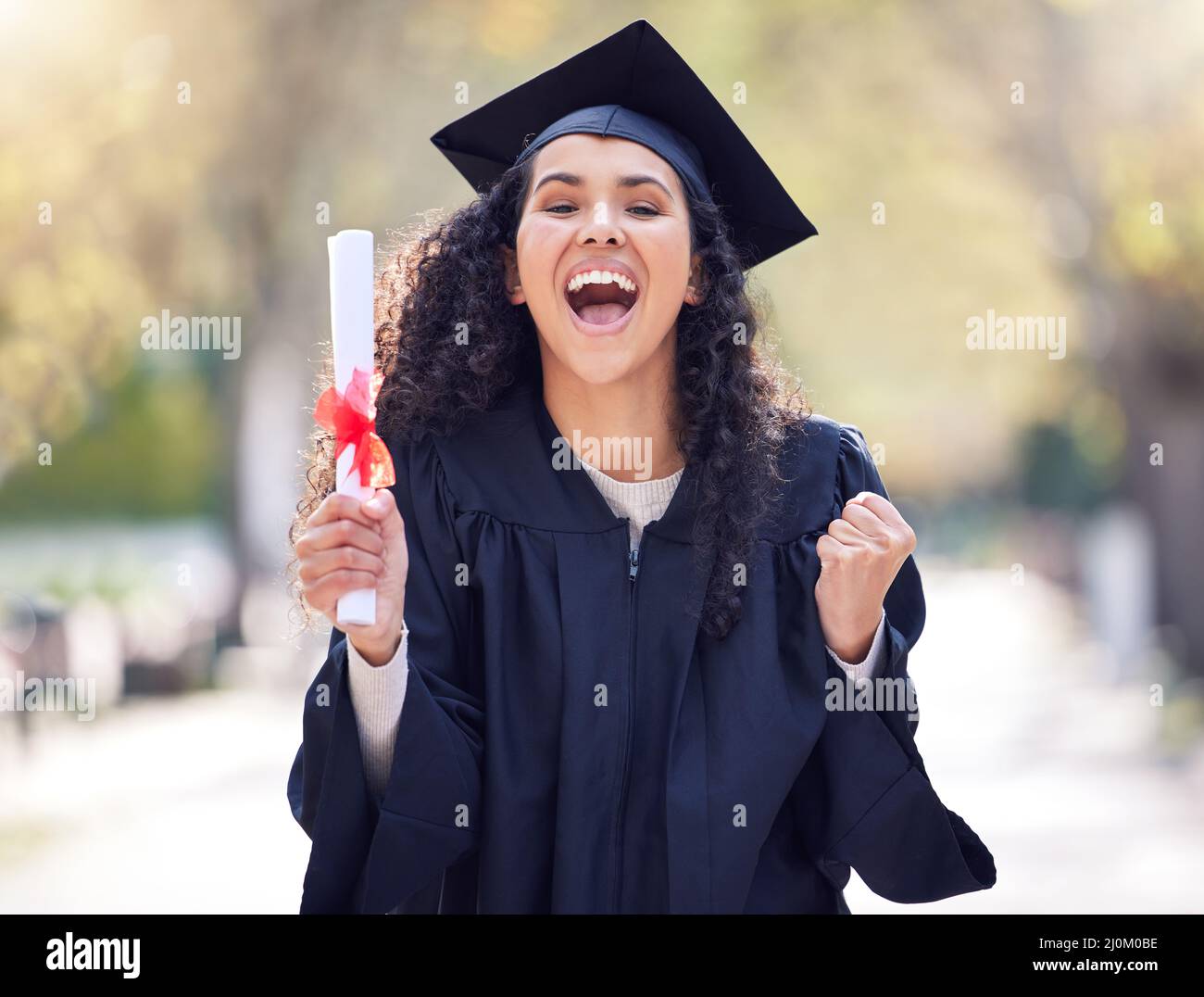 I reached high, I got rewarded. Shot of a young woman cheering on ...