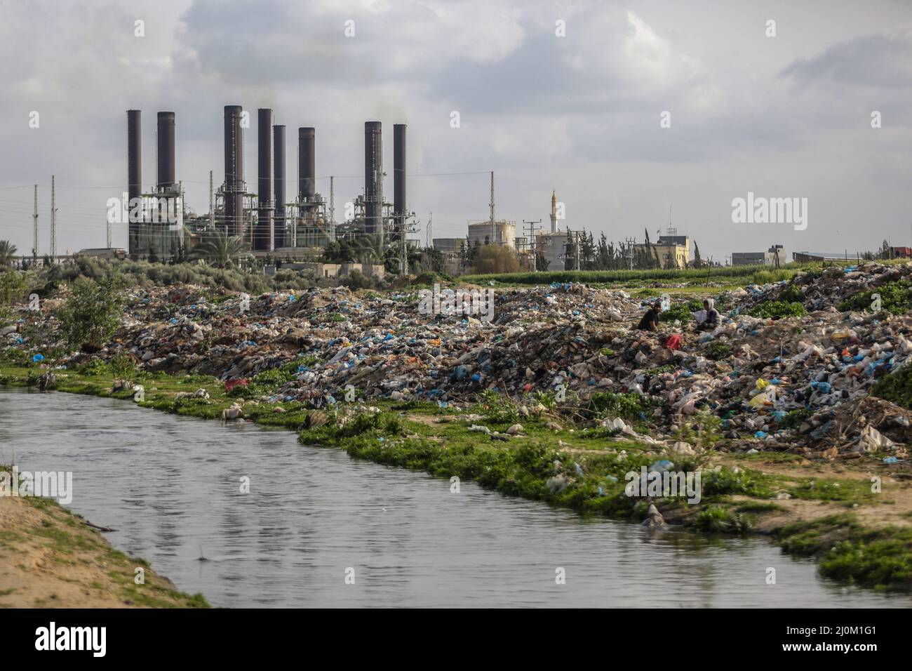 Gaza, Palestine. 19th Mar, 2022. Palestinian men work in sorting waste ...