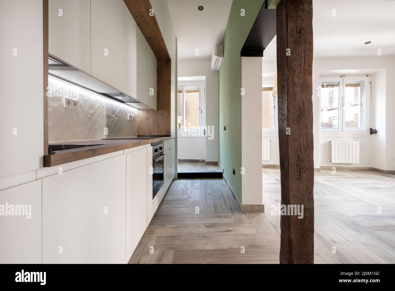 Single story kitchen with oak-topped white wood cabinets, stainless ...