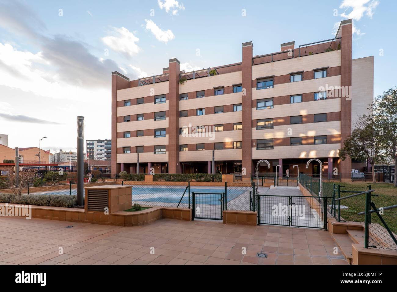 Facade of an urban residential apartment building with swimming pools ...